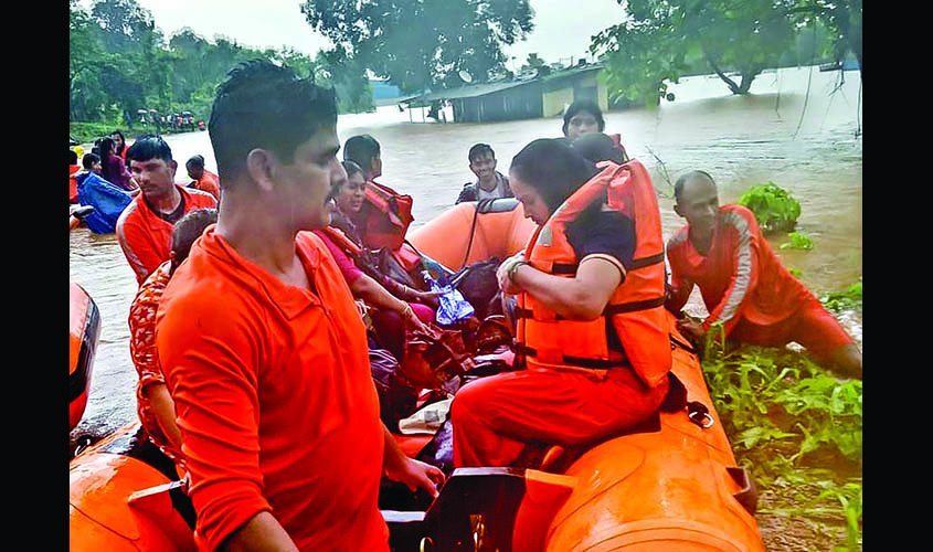 Thane: Passengers stranded in the Mahalaxmi Express on the flooded railway tracks at Vangani ...